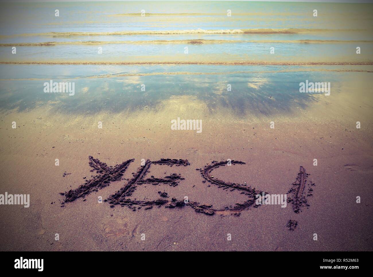 big YES written on the sand with vintage effect Stock Photo - Alamy