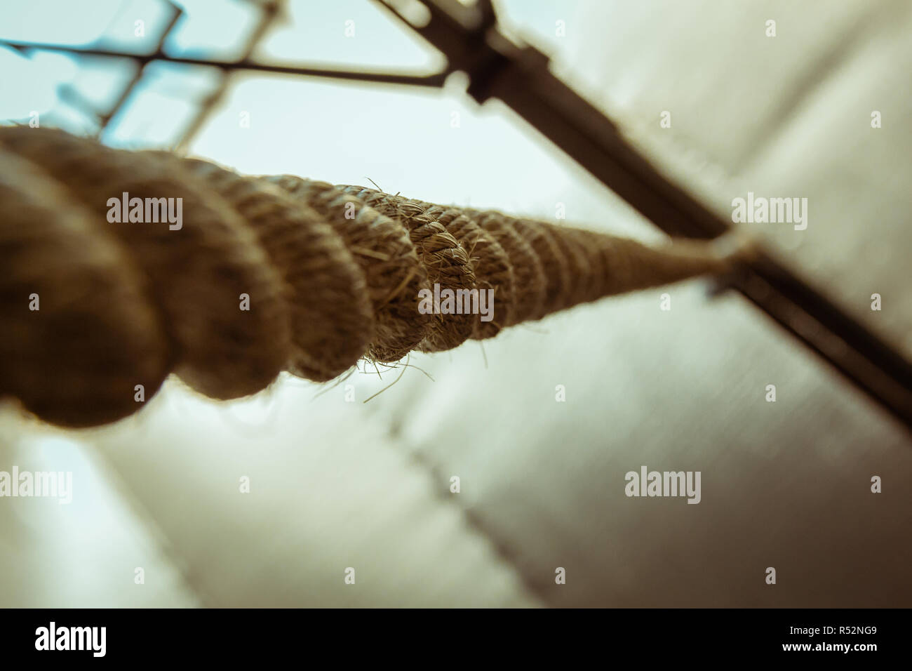 Brown climbing rope hanging from roof Stock Photo - Alamy