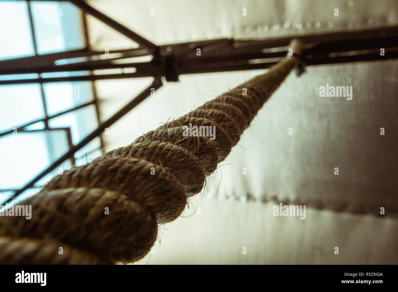 Brown climbing rope hanging from roof Stock Photo - Alamy