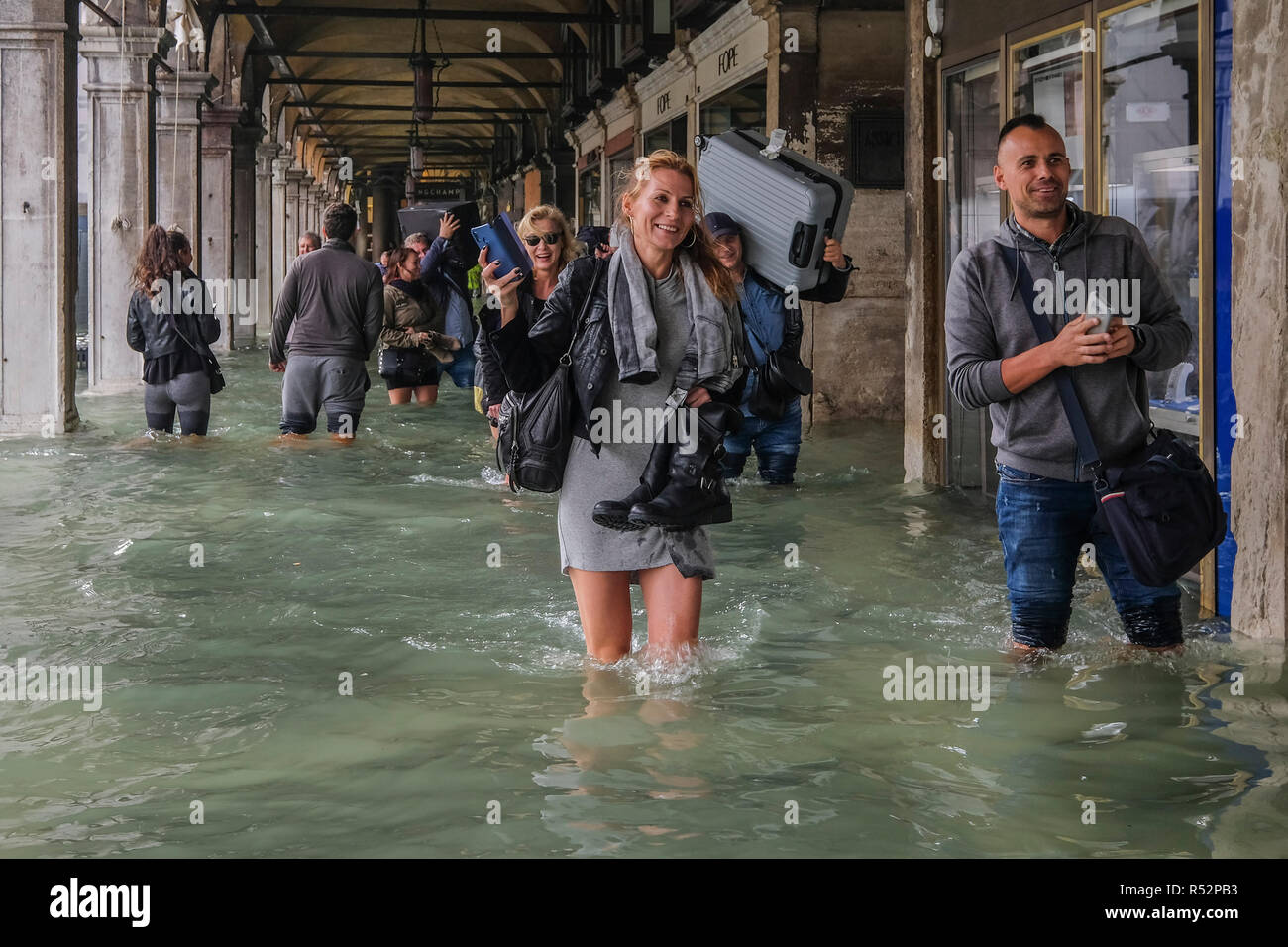 Venice, Italy. 29 October 2018. Tourists walk at the flooded St. Mark ...