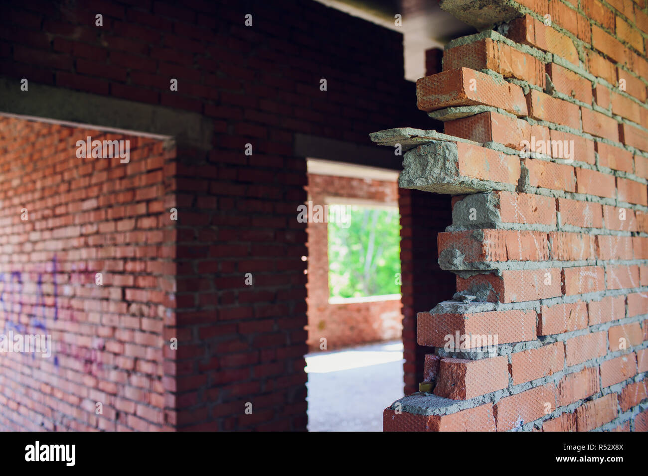 The hole from rocket in brick wall Stock Photo - Alamy