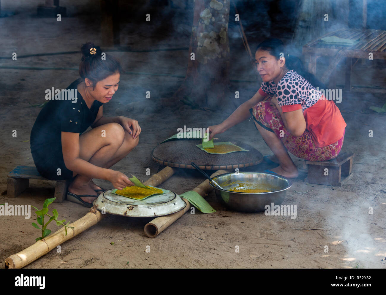 Don Daeng, Laos - April 27, 2018: Local women cooking a traditional ...