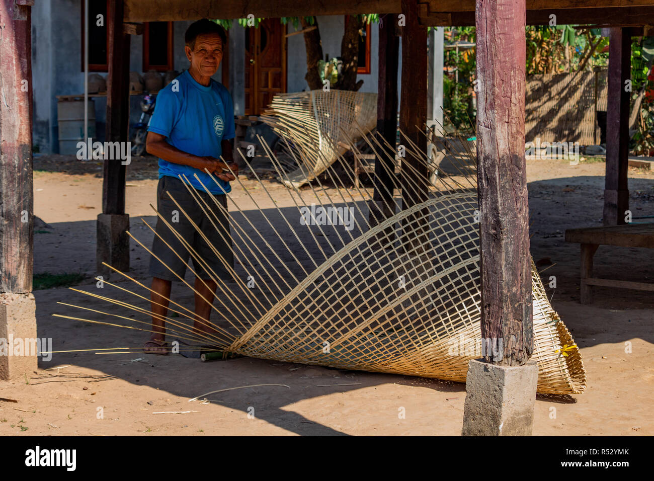 Don Daeng, Laos - April 27, 2018: Villager making a big bamboo basket ...