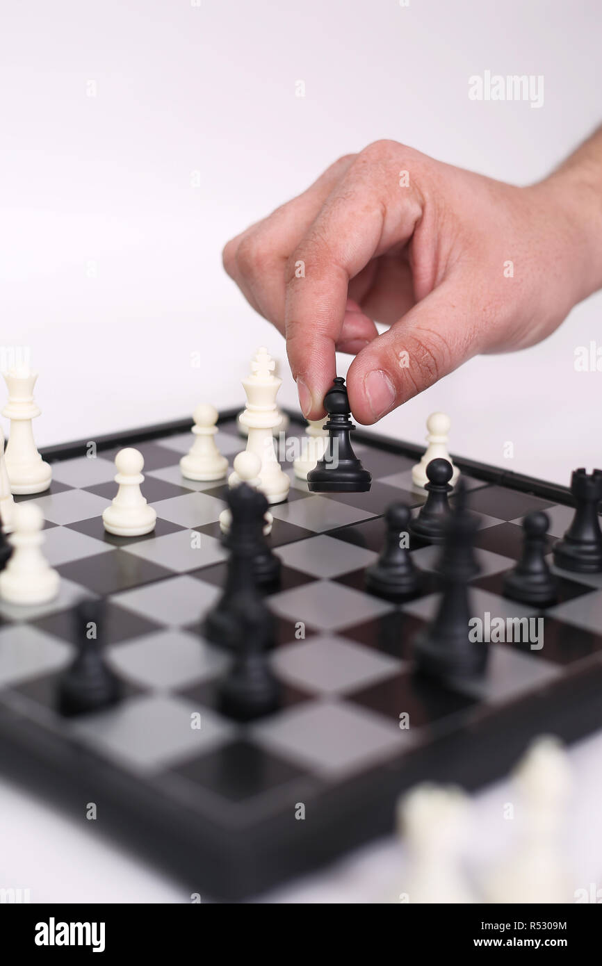 Hand is playing chess. Isolated on the white background Stock Photo - Alamy
