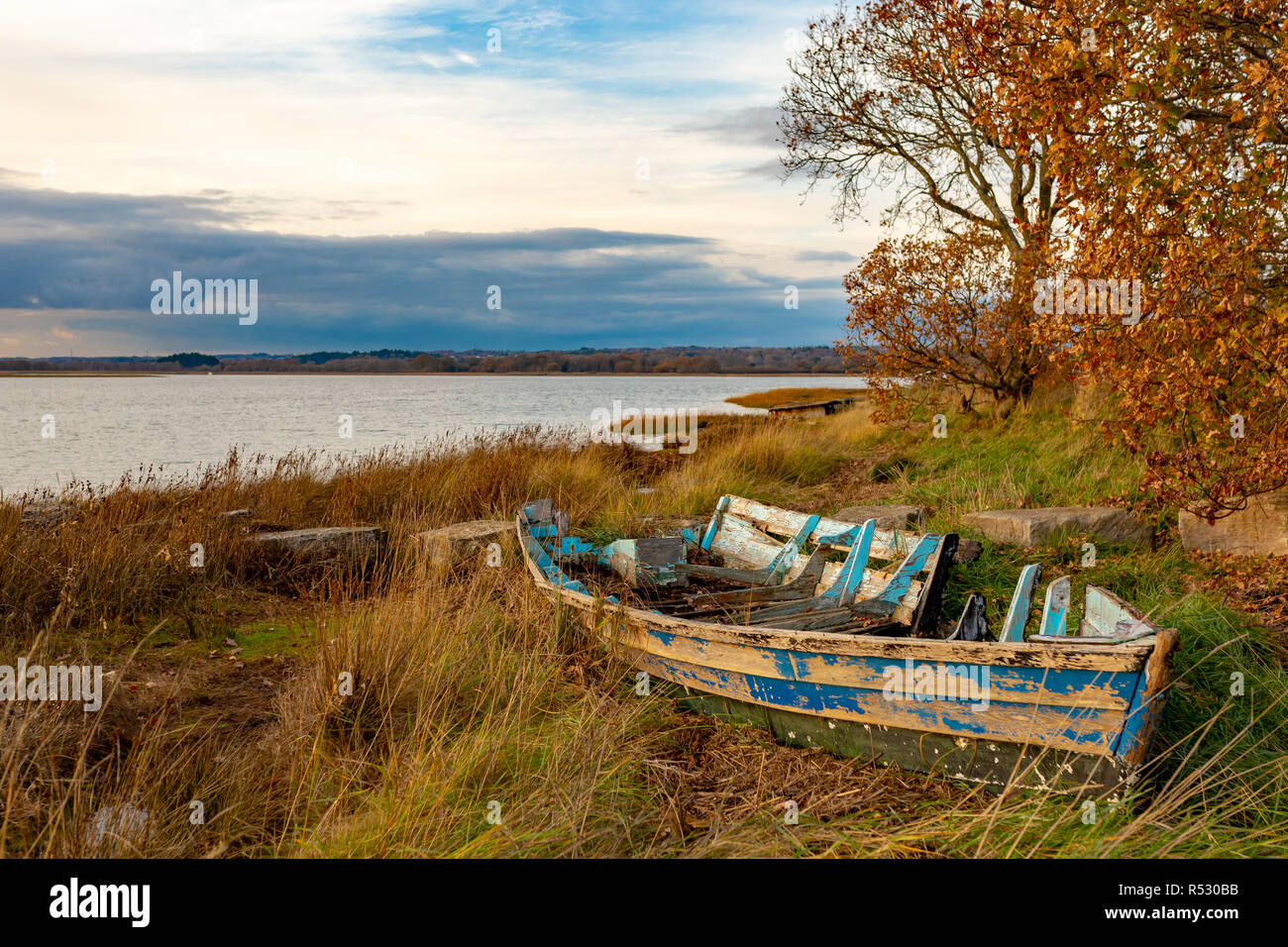 Landscape photograph with abandoned neglected boat in foreground ...