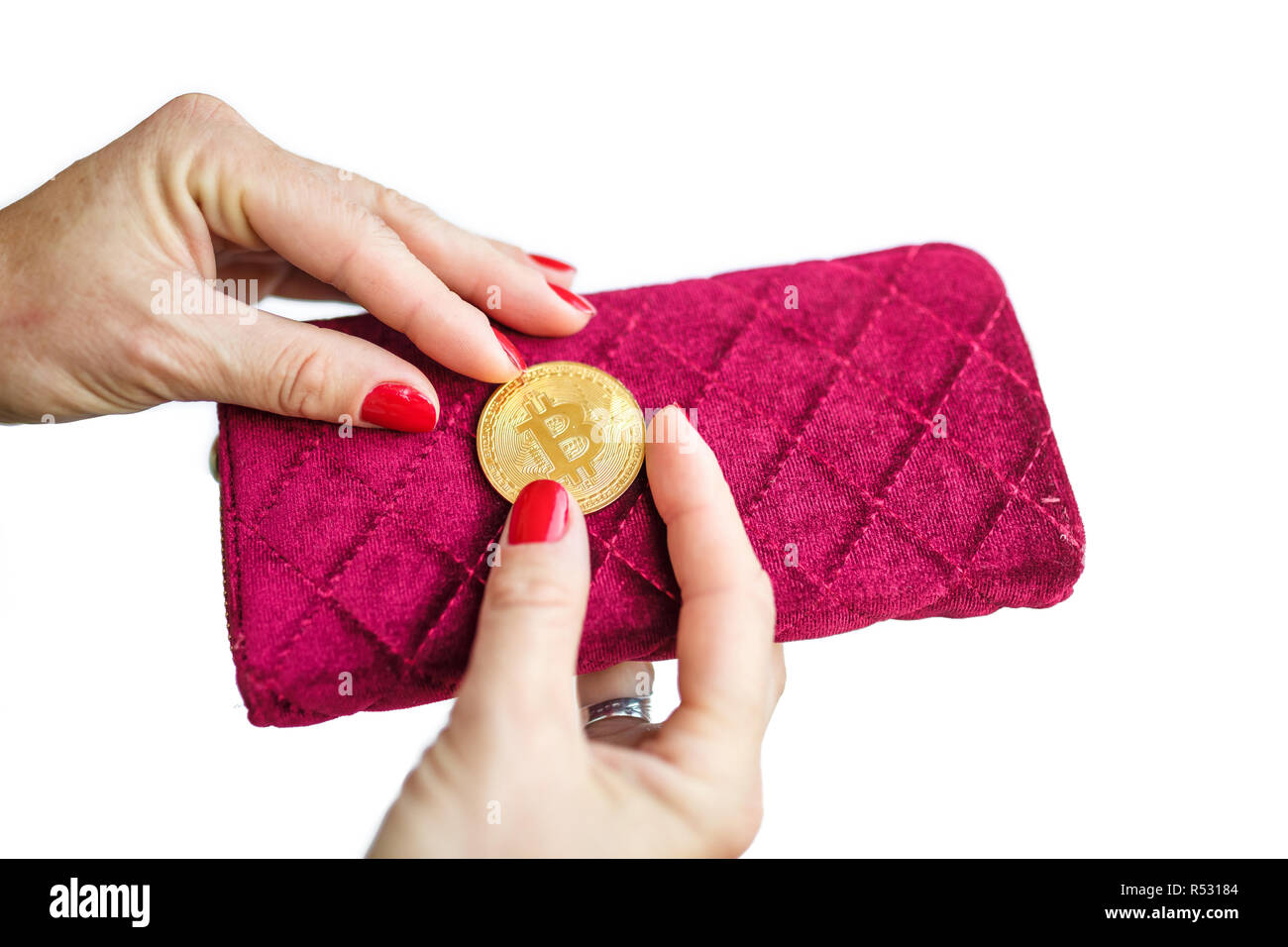 virtual money golden bitcoin on pink women fabric purse. fingers with ...
