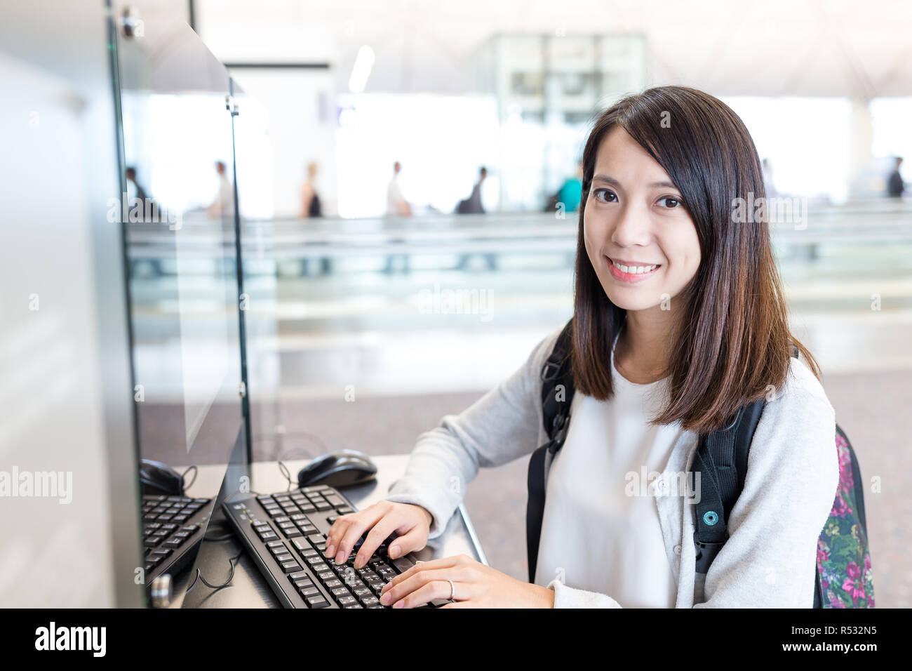 Woman use of computer in the airport Stock Photo - Alamy
