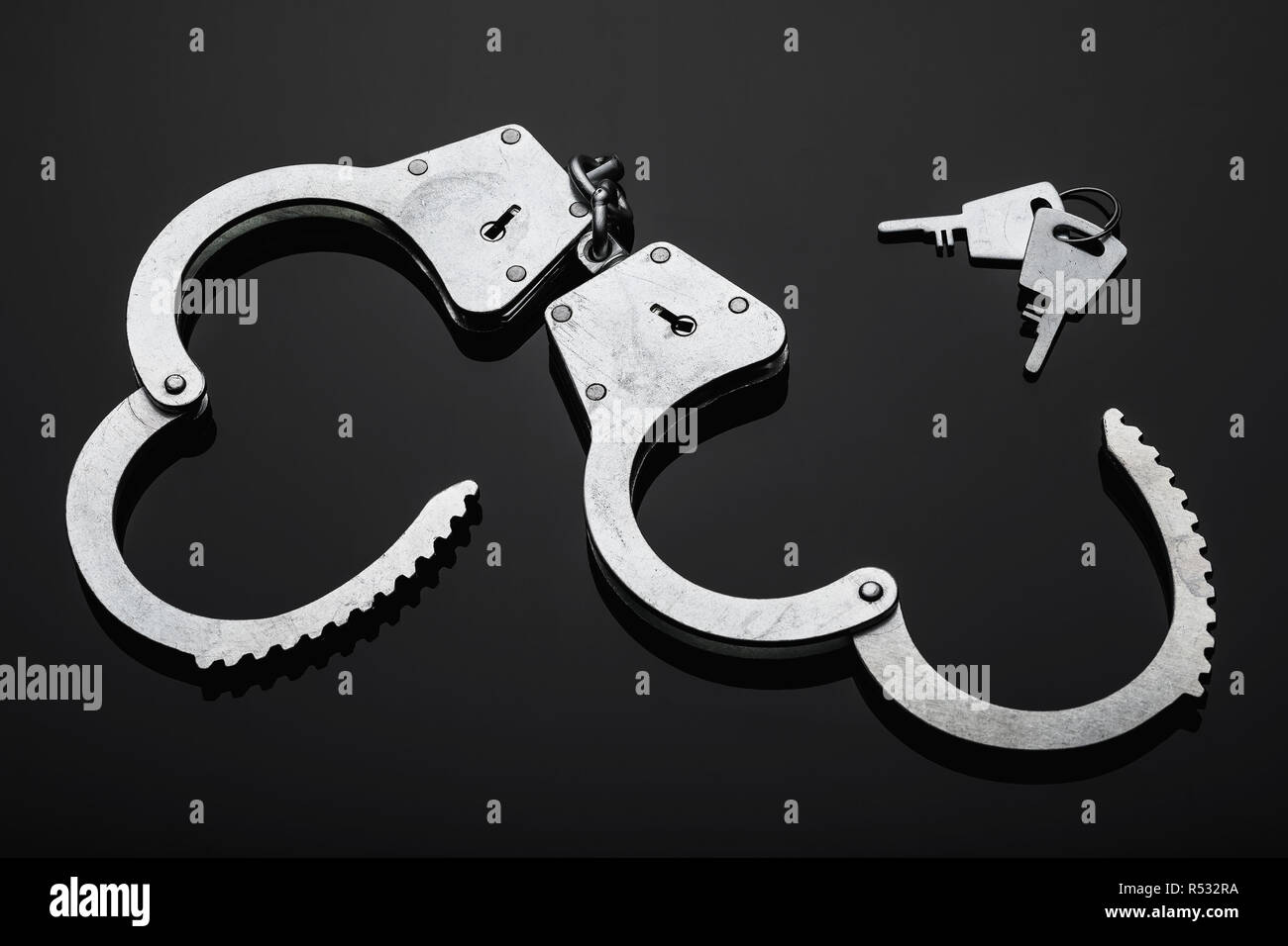 Open handcuffs hi-res stock photography and images - Alamy
