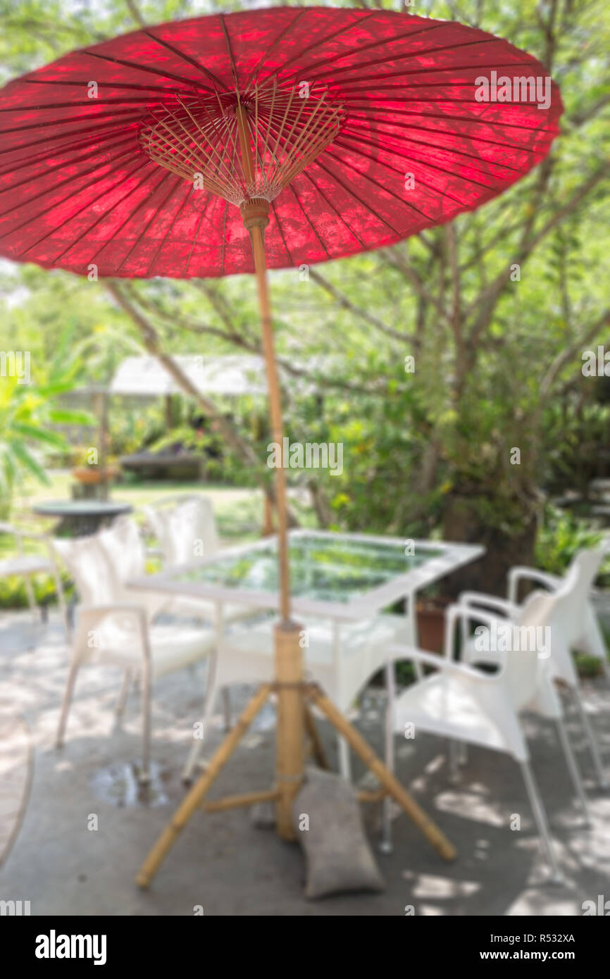 Outdoor Seats In Garden With Umbrella Stock Photo - Alamy