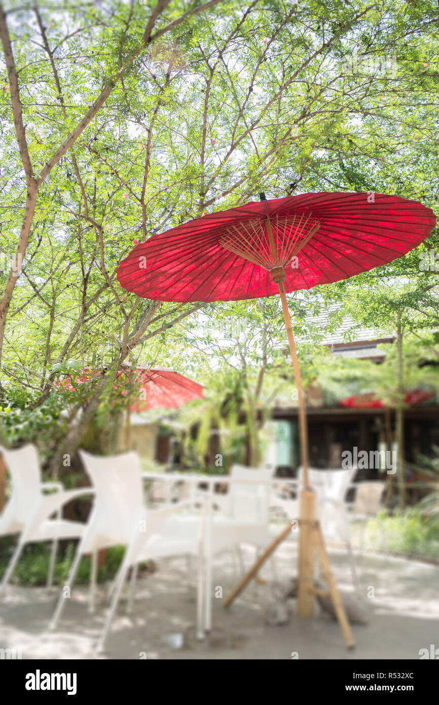 Outdoor Seats In Garden With Umbrella Stock Photo - Alamy