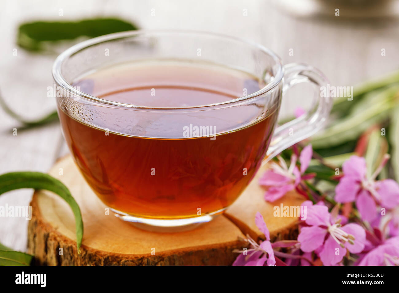 Traditional Russian herbal drink Ivan-tea in transparent cup close-up ...