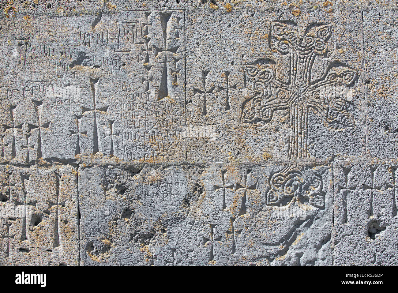 A wall of tuff stone carved with a cross - Khachkars Stock Photo - Alamy
