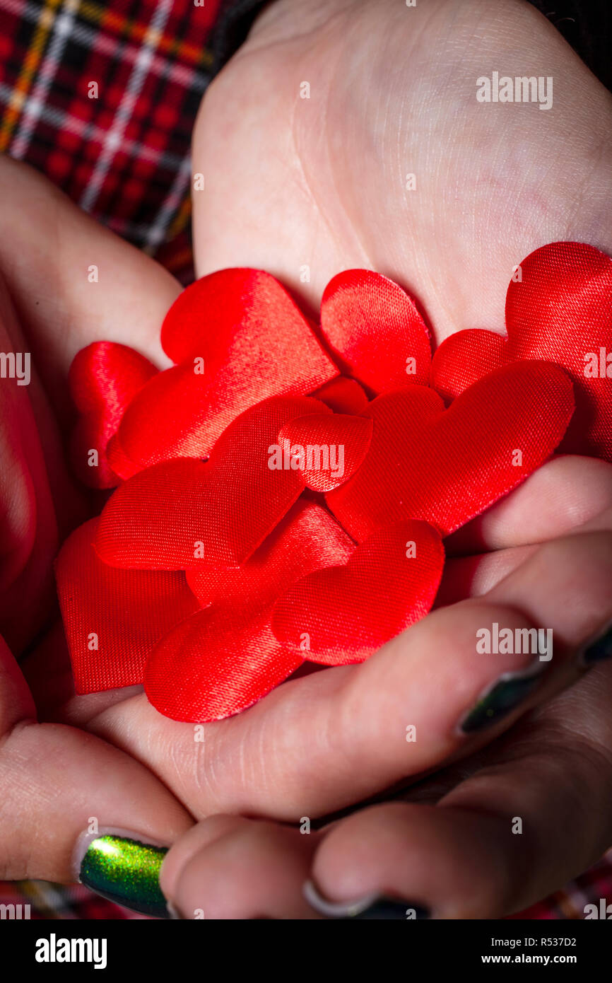 little red hearts in the hands Stock Photo - Alamy
