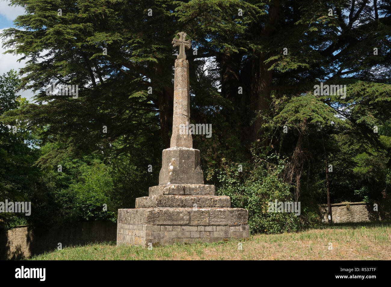 The stone cross on the village green in Sandford St Martin, West ...