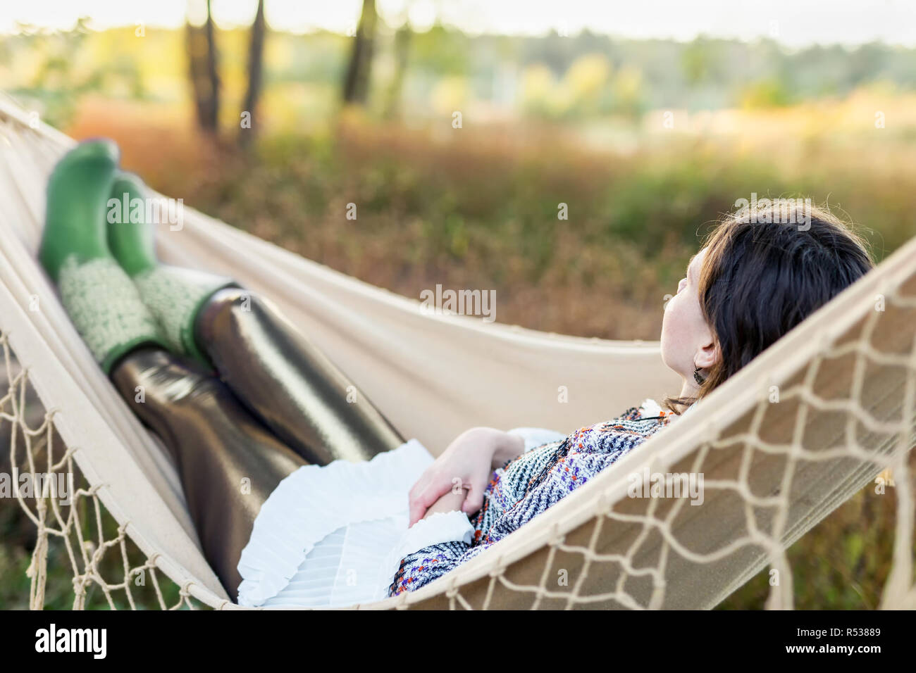 Young woman relaxing in a hammock outdoors Stock Photo - Alamy