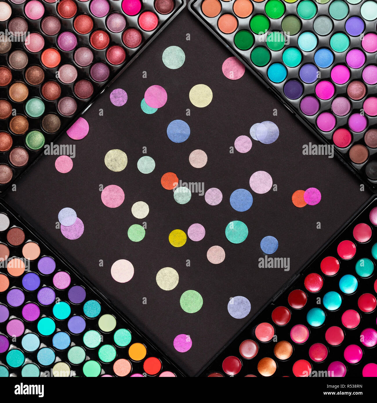 Cosmetic make-up palettes background with scattered colorful confetti ...