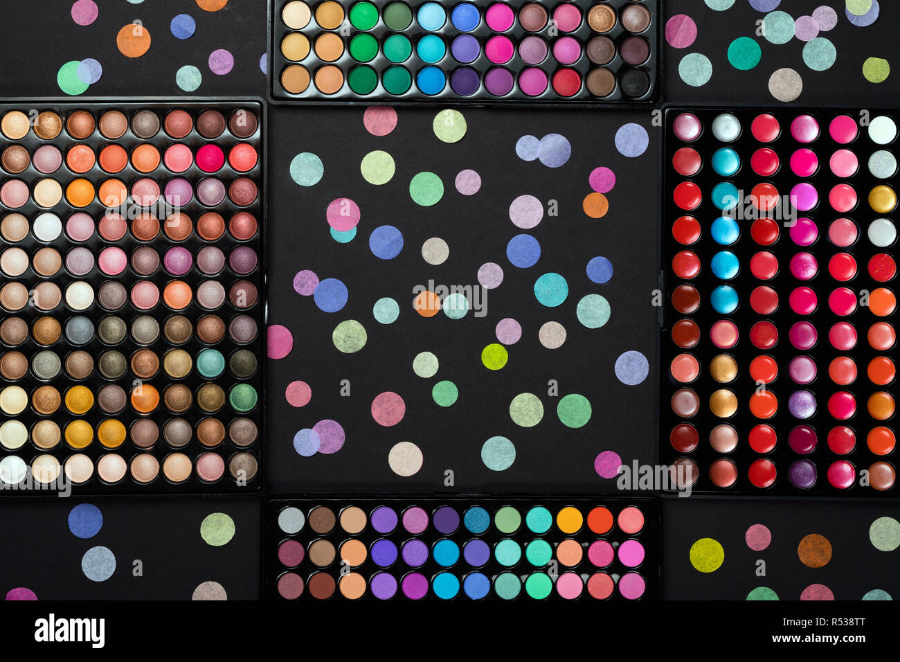 Cosmetic make-up palettes with scattered colorful confetti on black ...