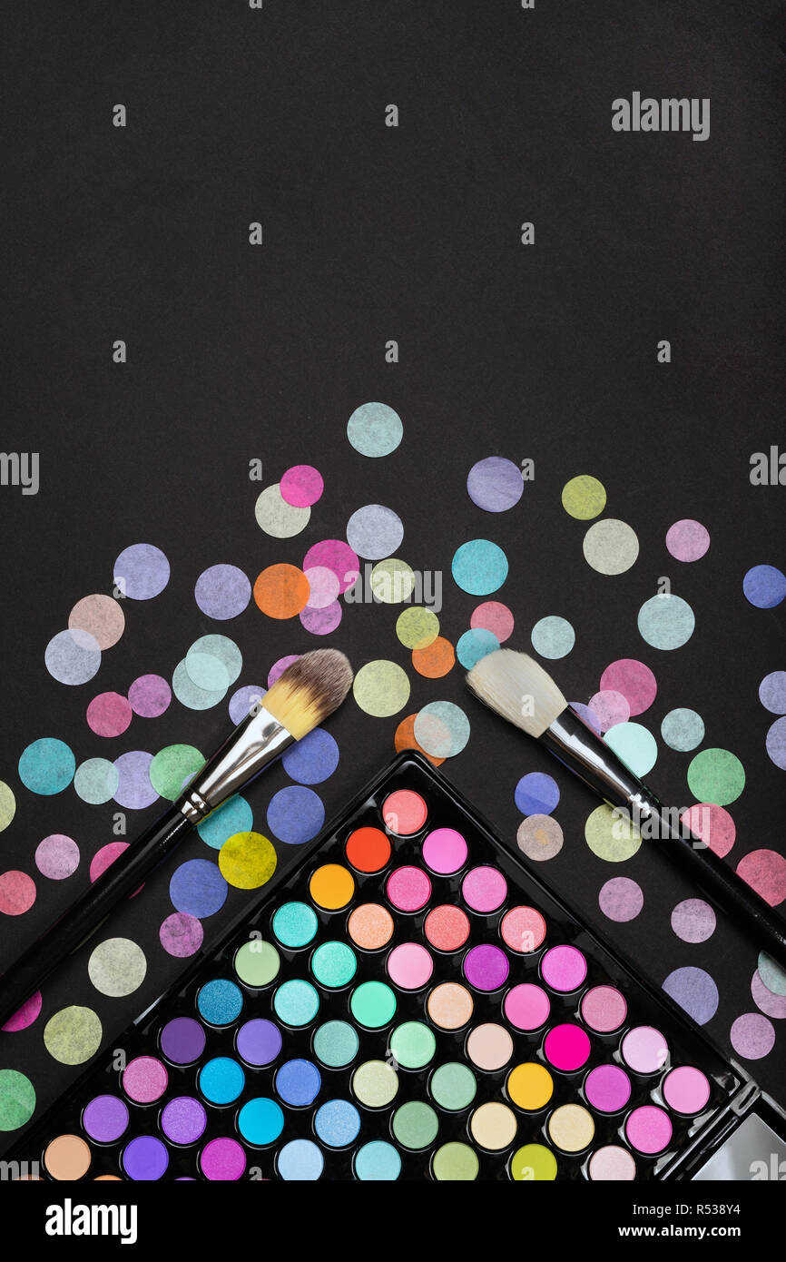 Cosmetic background with makeup brushes and eyeshadow palette on a ...