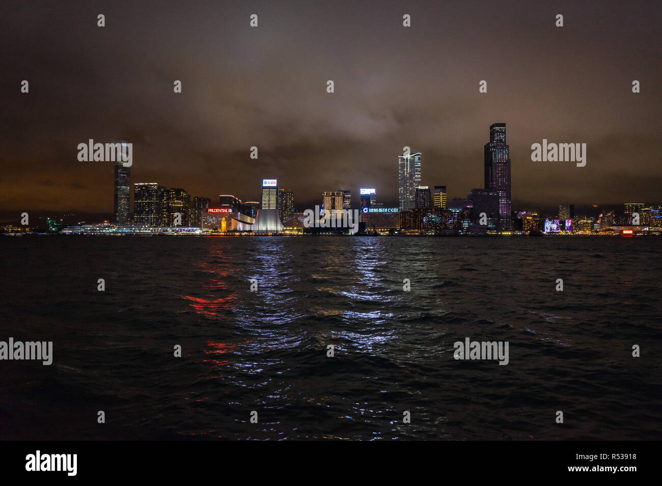Kowloon skyline at night viewed from Wan Chai waterfront. Hong Kong ...