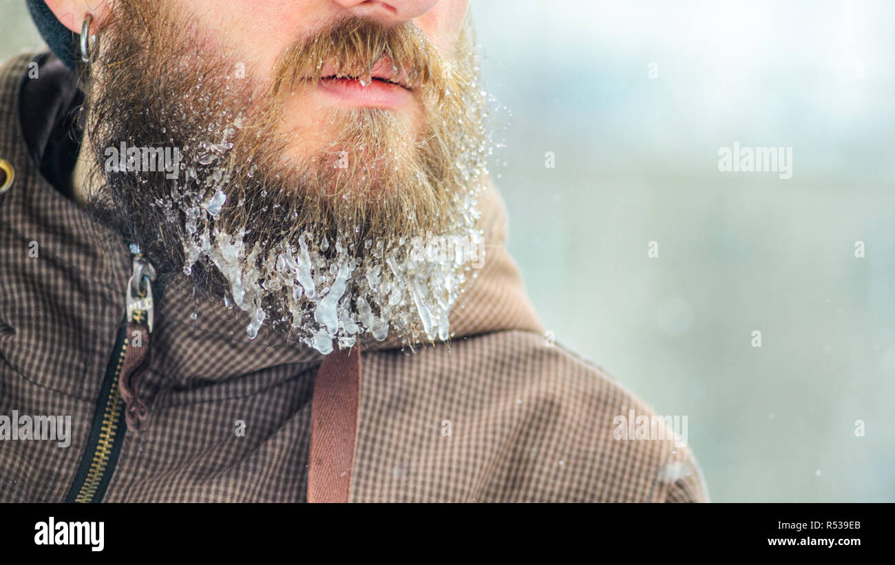 Part of the face of a serious and worried man is an icy beard with ...