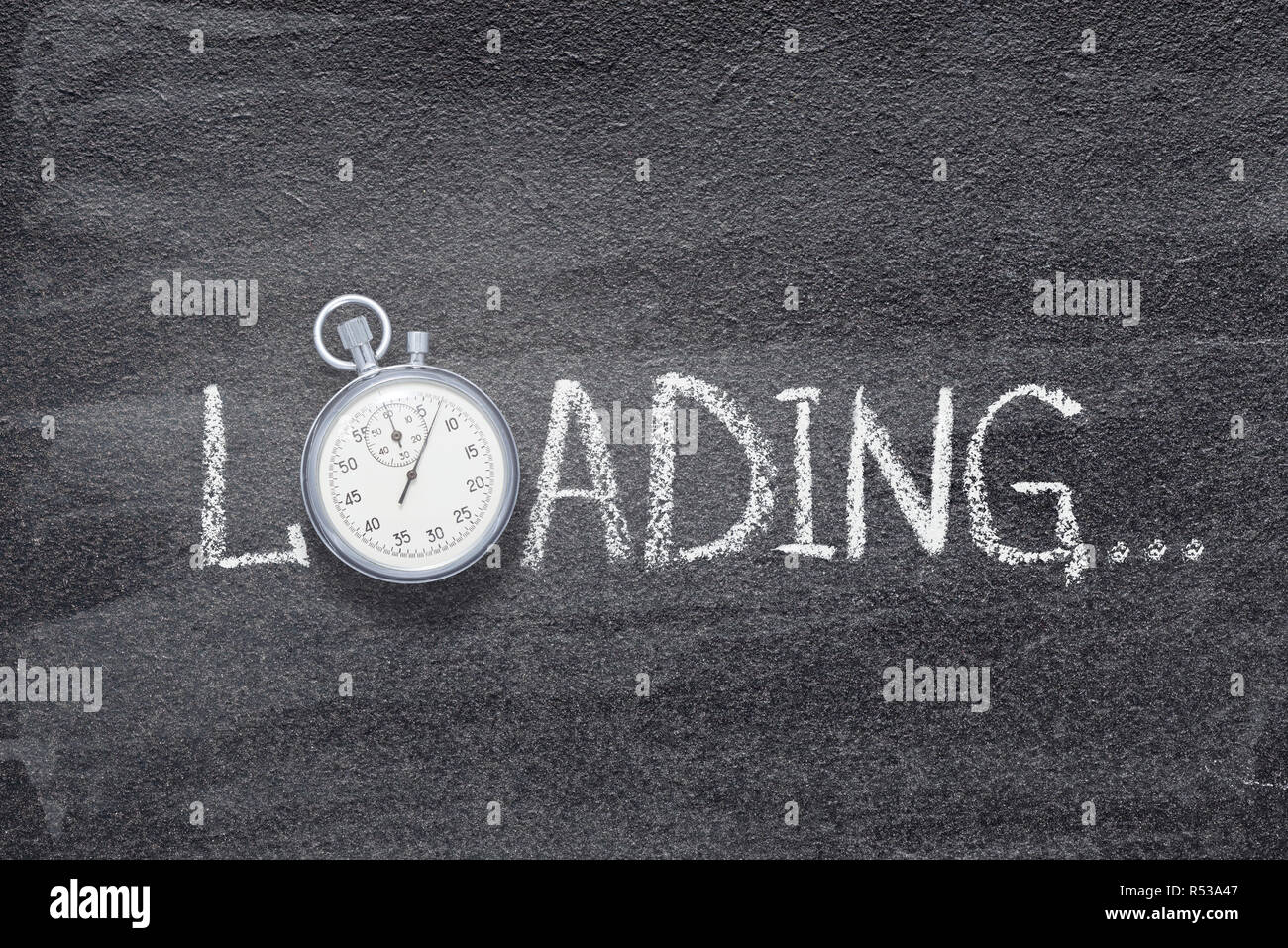 loading word written on chalkboard with vintage stopwatch used instead ...