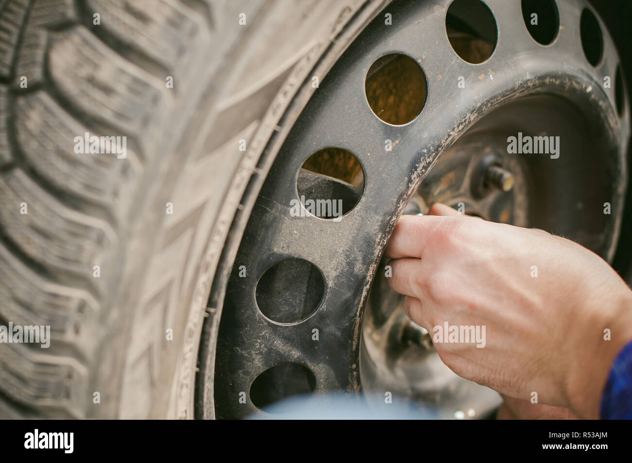 man changing a wheel on the road. on way there was breakage of wheel ...