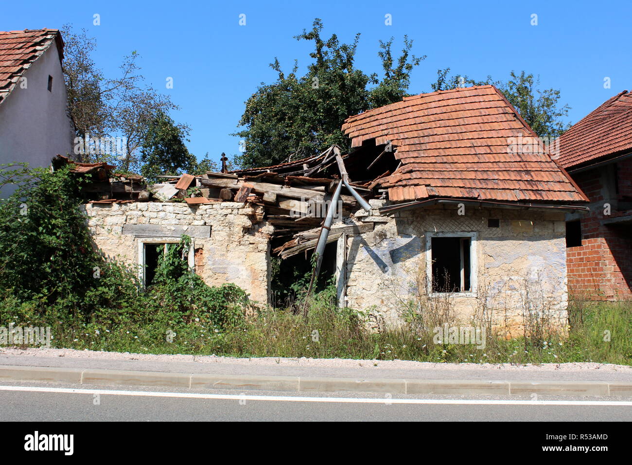 Small family brick house with destroyed roof, doors and windows during ...
