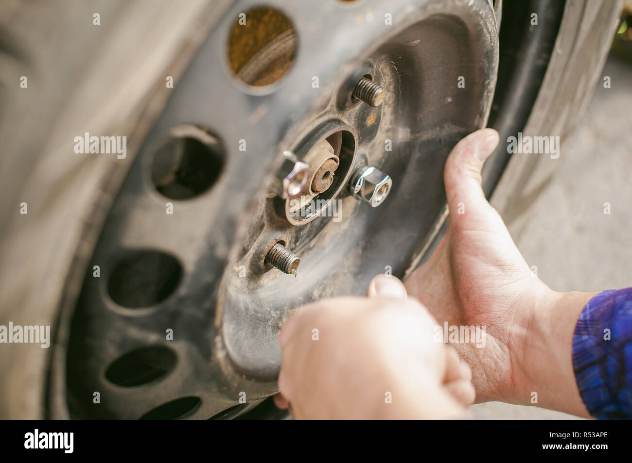man changing a wheel on the road. on way there was breakage of wheel ...