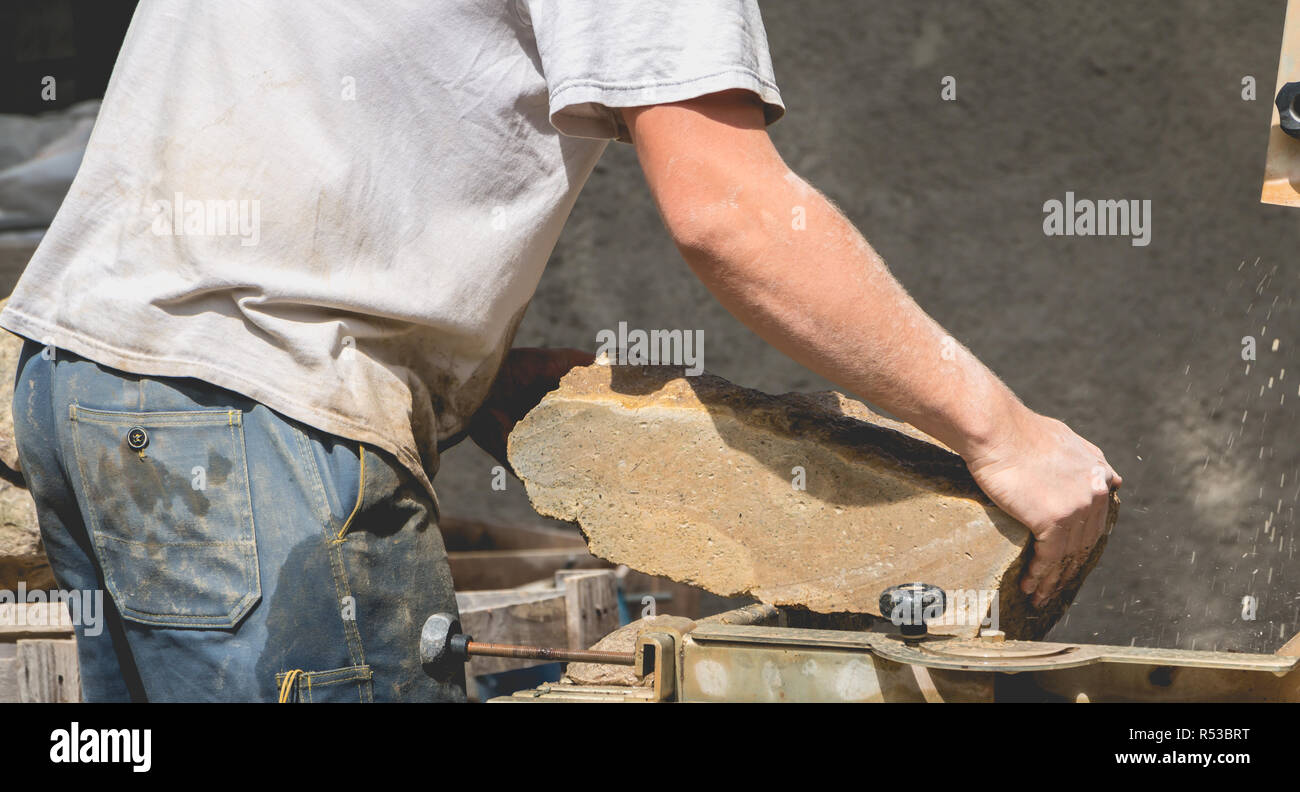 man cutting a stone with a water saw Stock Photo - Alamy