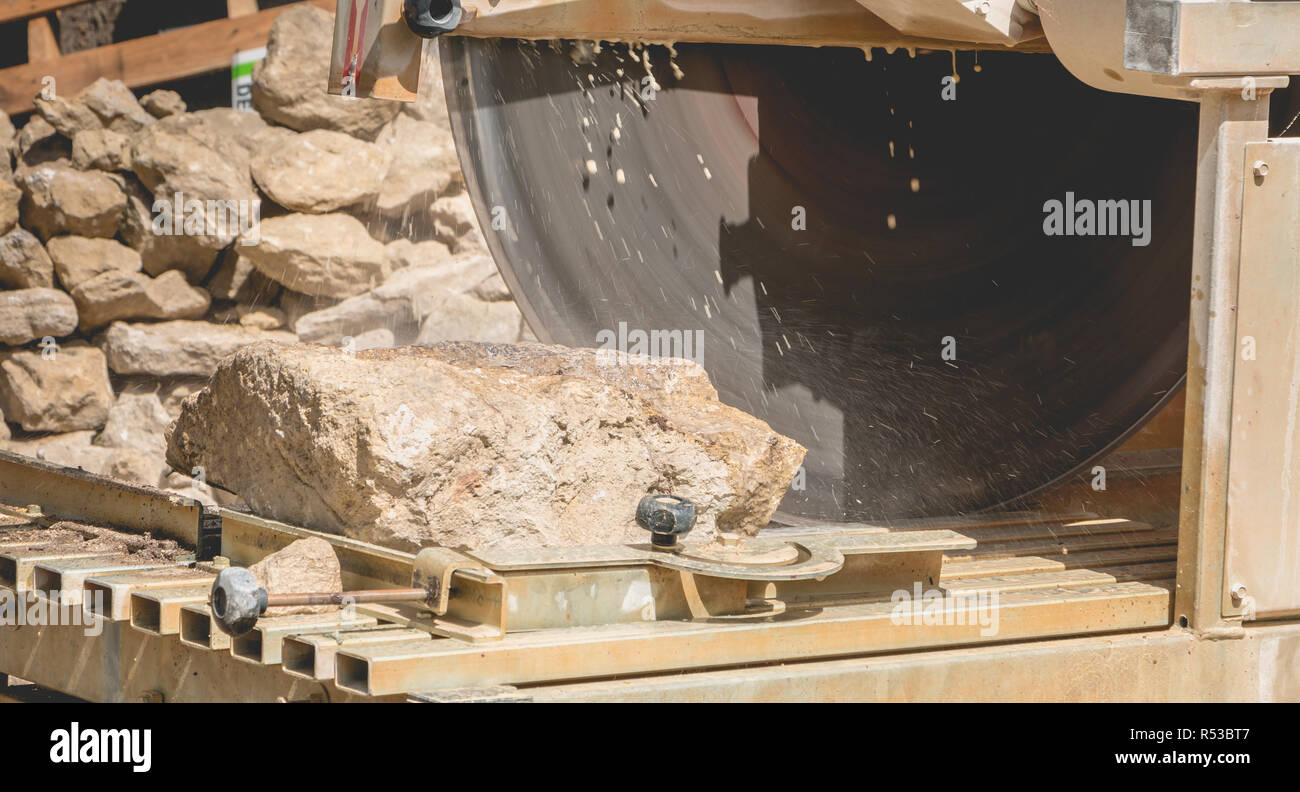man cutting a stone with a water saw Stock Photo - Alamy