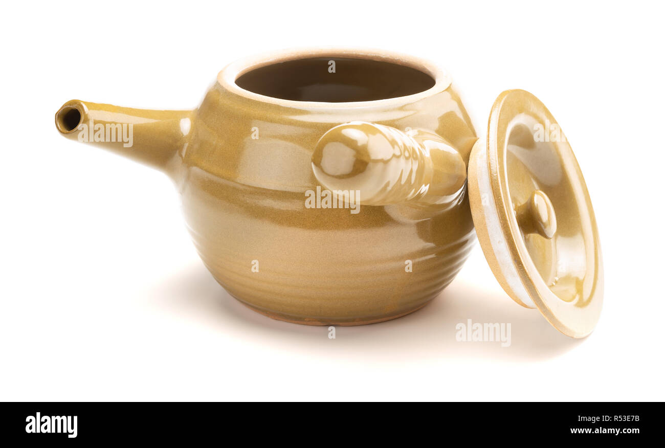 side view clay pot for boiling herb medicing with the lid open on white ...