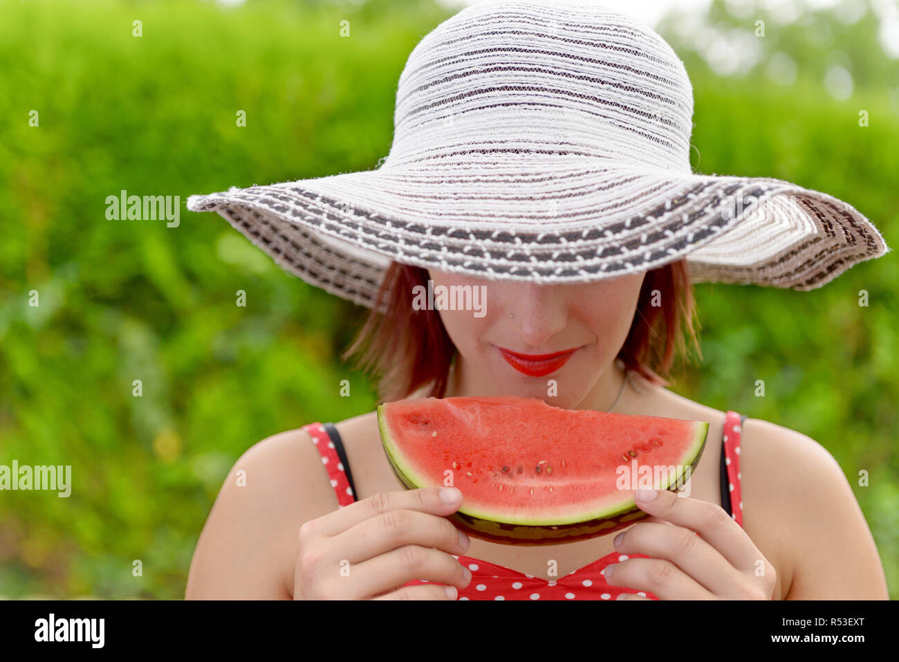 Beautiful girl eating a watermelon Stock Photo - Alamy