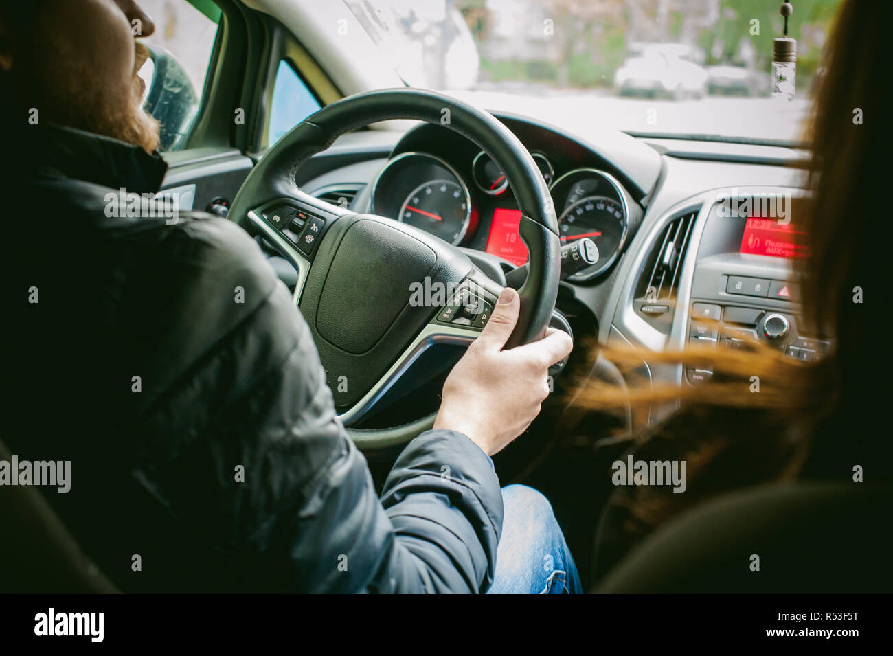 man drives a car. A guy in a jacket sits behind the wheel of a car ...