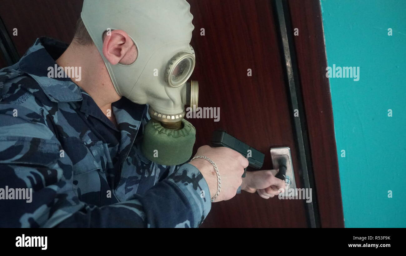 Guard dressed in military uniform in a gas mask Stock Photo - Alamy