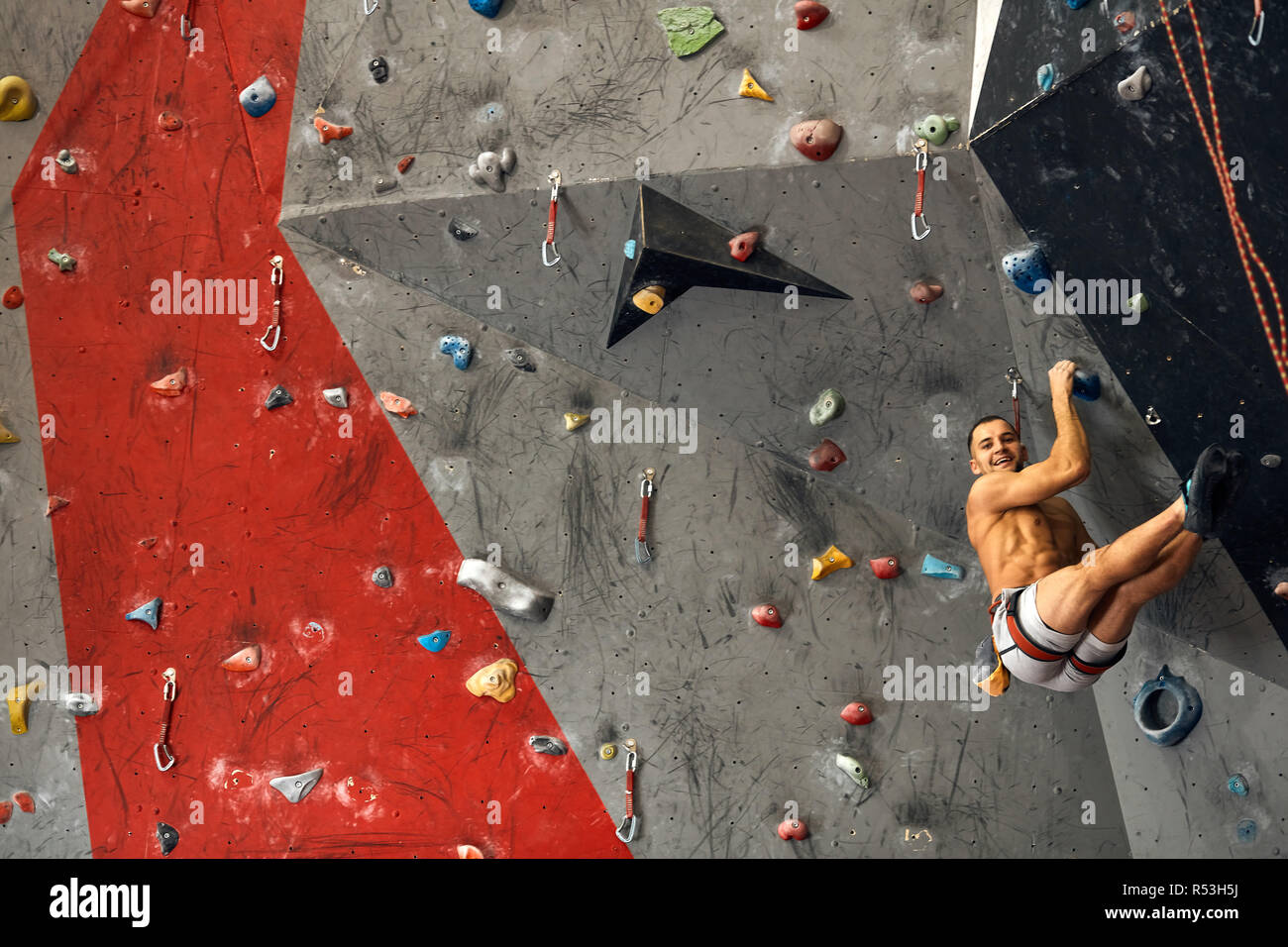 Panoramic man bouldering at an indoor climbing centre Stock Photo - Alamy
