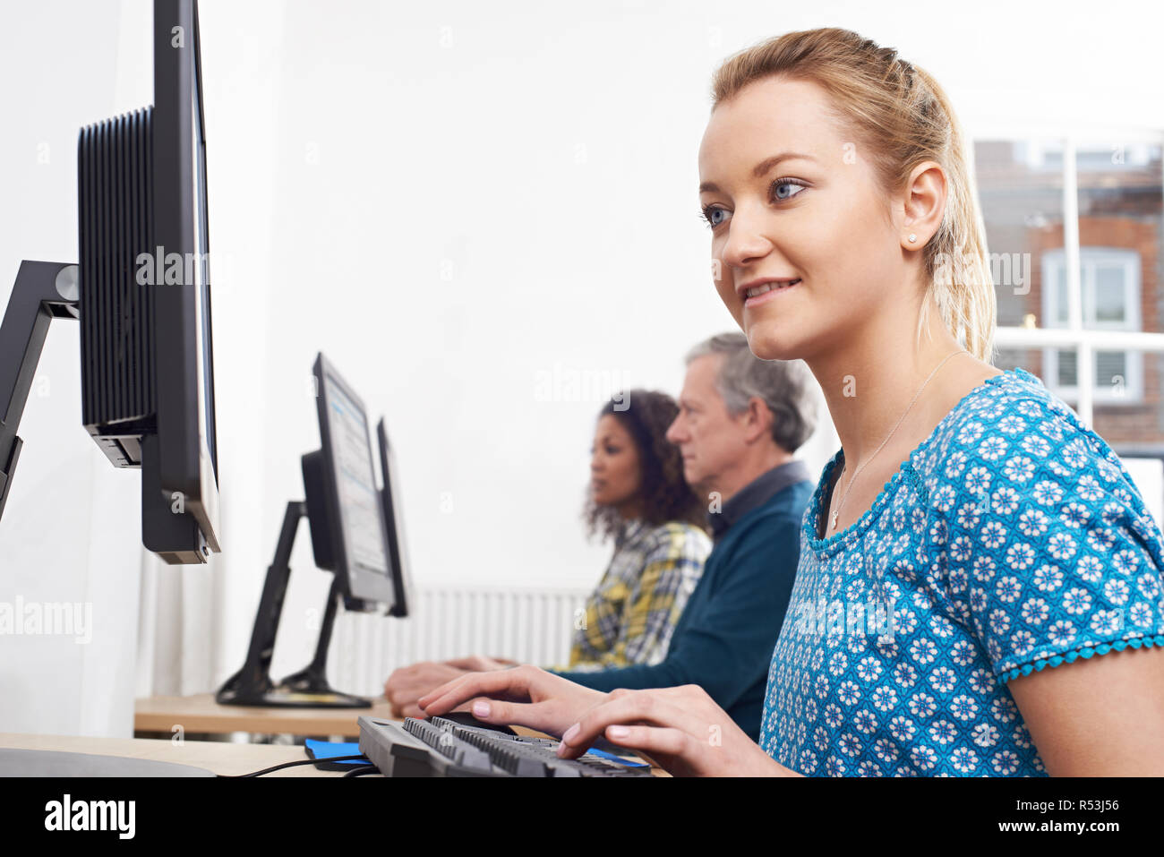 Young Woman Attending Computer Class In Front Of Screen Stock Photo - Alamy