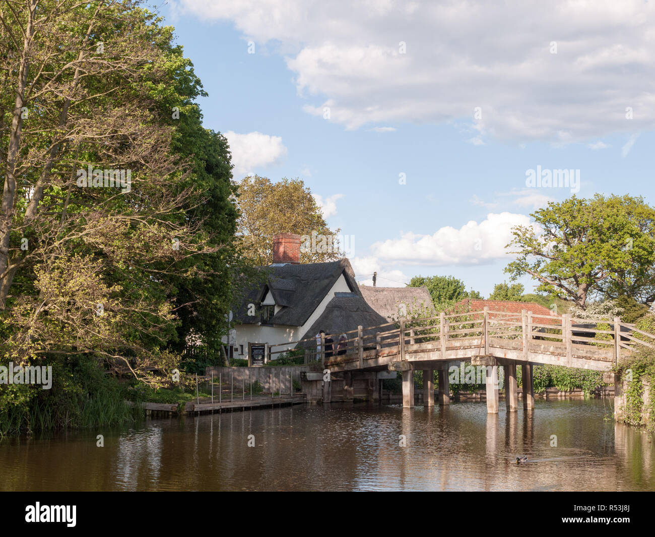 the bridge at flatford mill leading to a cottage in the heartland of ...