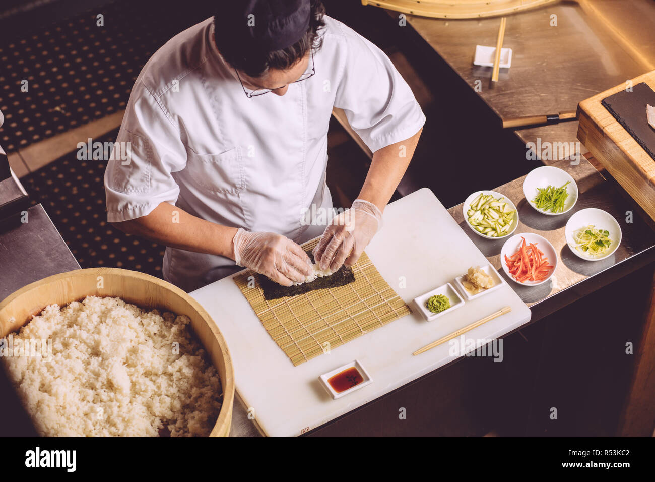 close up photo. top view awesome guy putting rice for roll Stock Photo ...