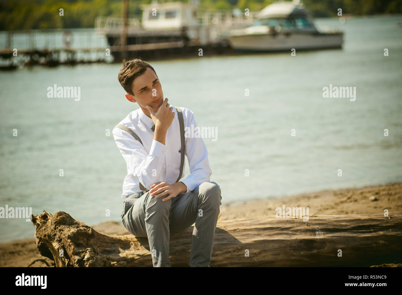 young skinny man, elegantly stylishly dressed in white shirt, gray ...