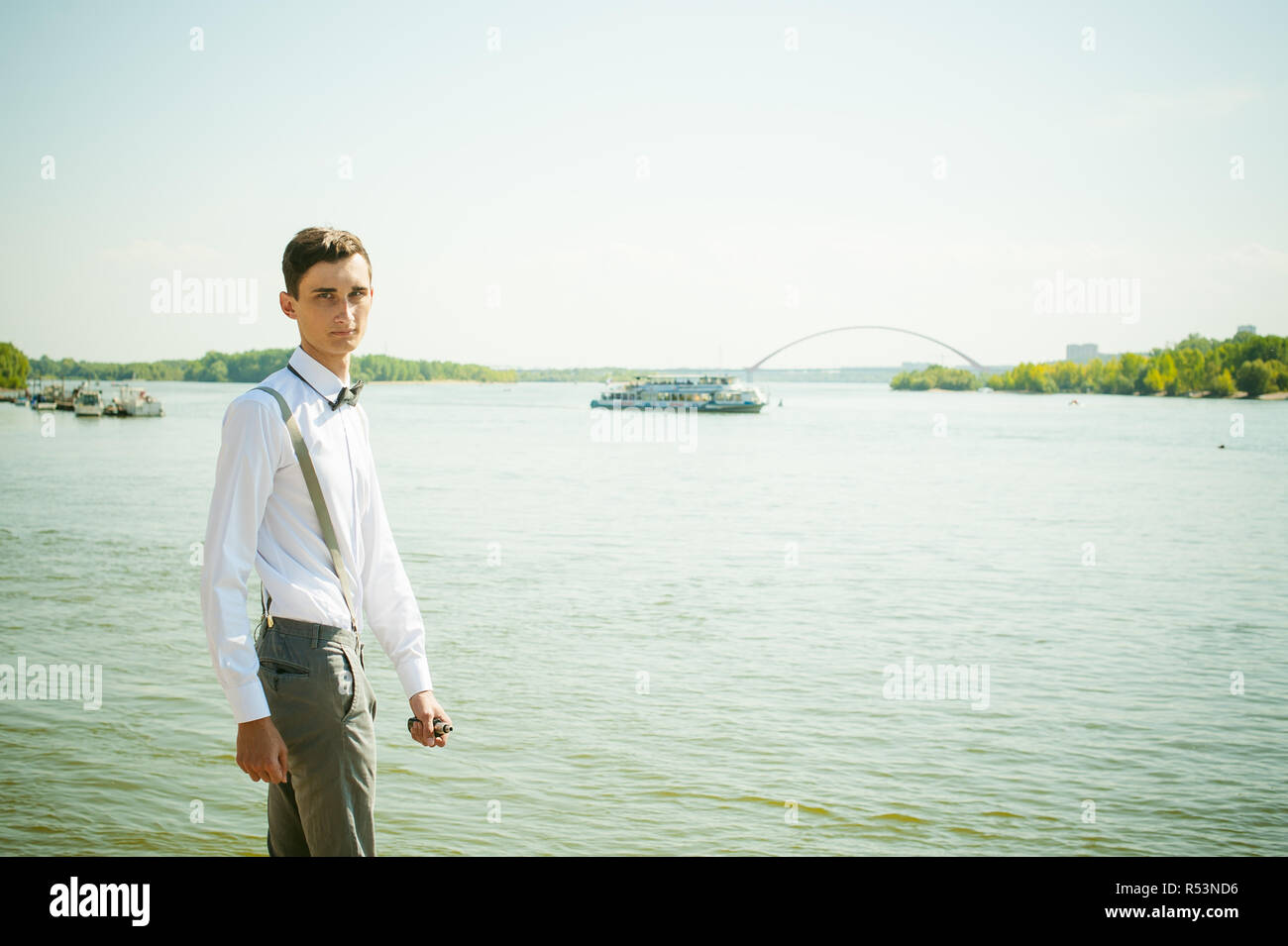 young skinny man, elegantly stylishly dressed in white shirt, gray ...