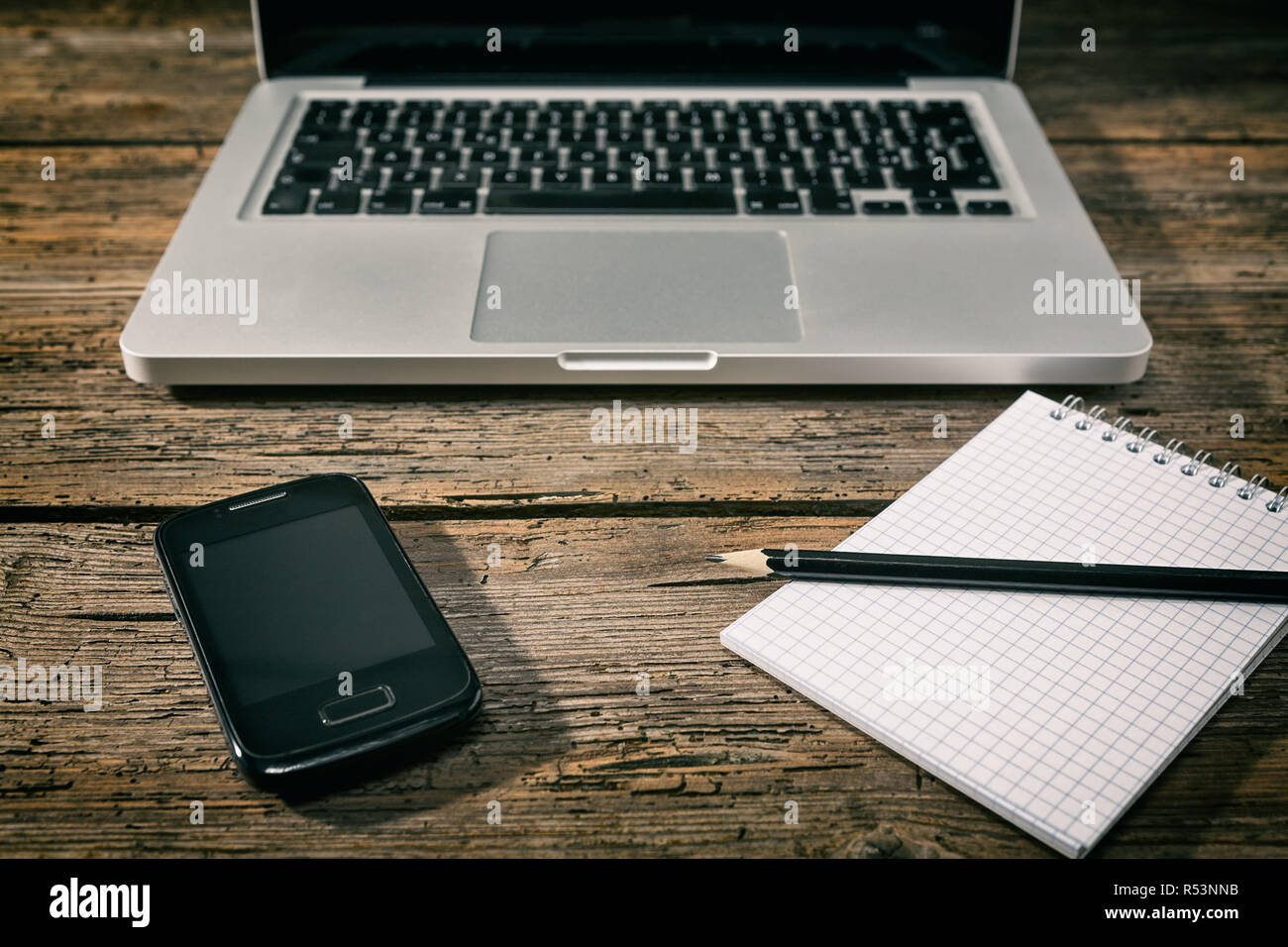Office workstation with laptop, smartphone and notebook Stock Photo - Alamy