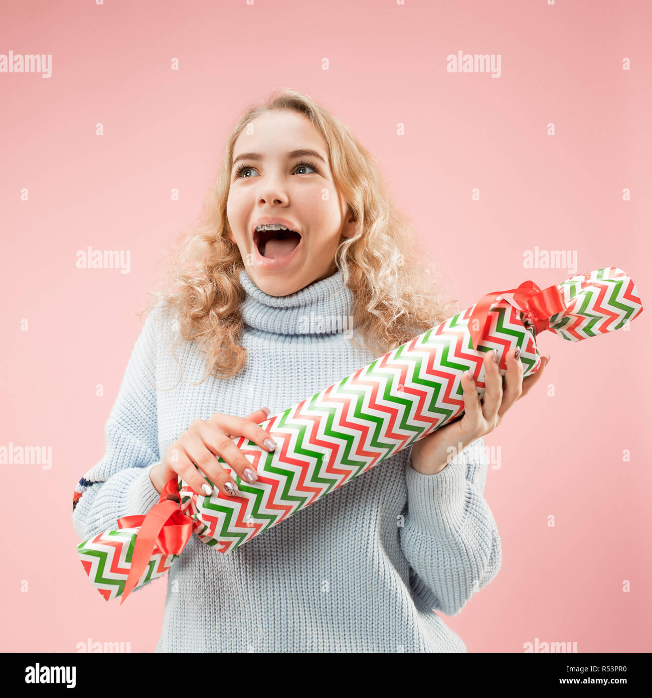 The surprised woman with big colorful gift box. Soft colors. Christmas ...