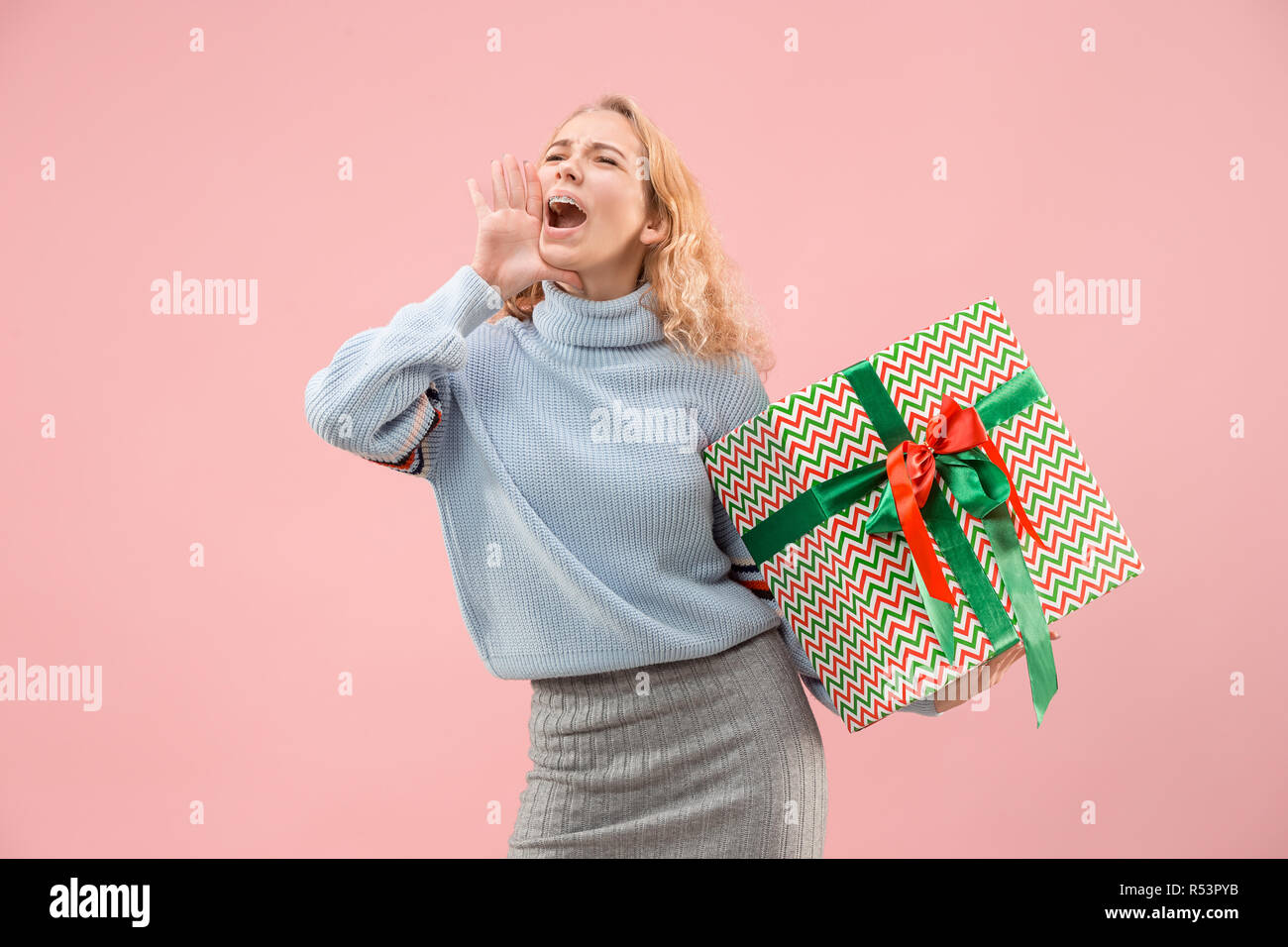 The surprised woman with big colorful gift box. Soft colors. Christmas ...