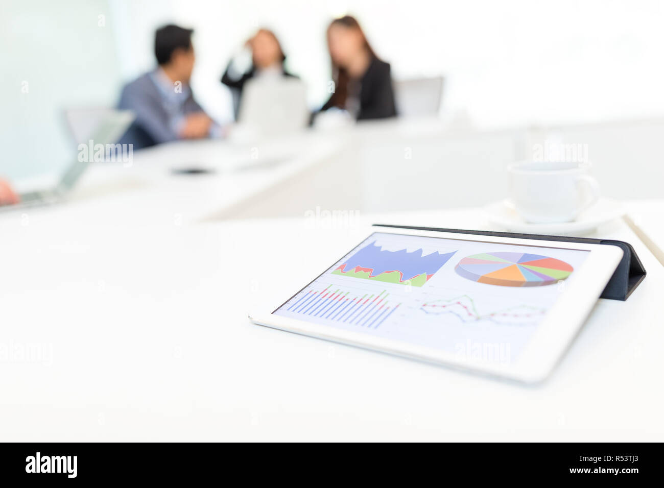 Digital tablet showing data chart on screen at business meeting room ...