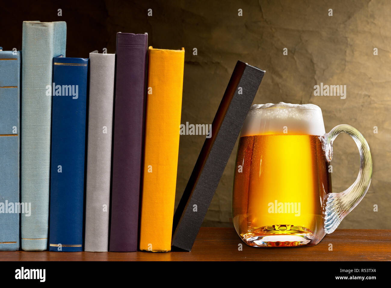 Glass of beer with books in the library Stock Photo - Alamy