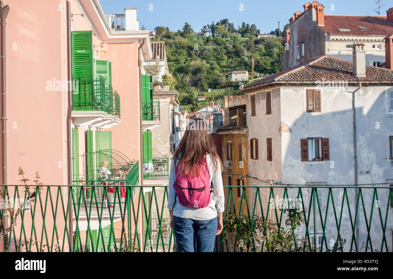 Woman looking down from balcony hi-res stock photography and images - Alamy