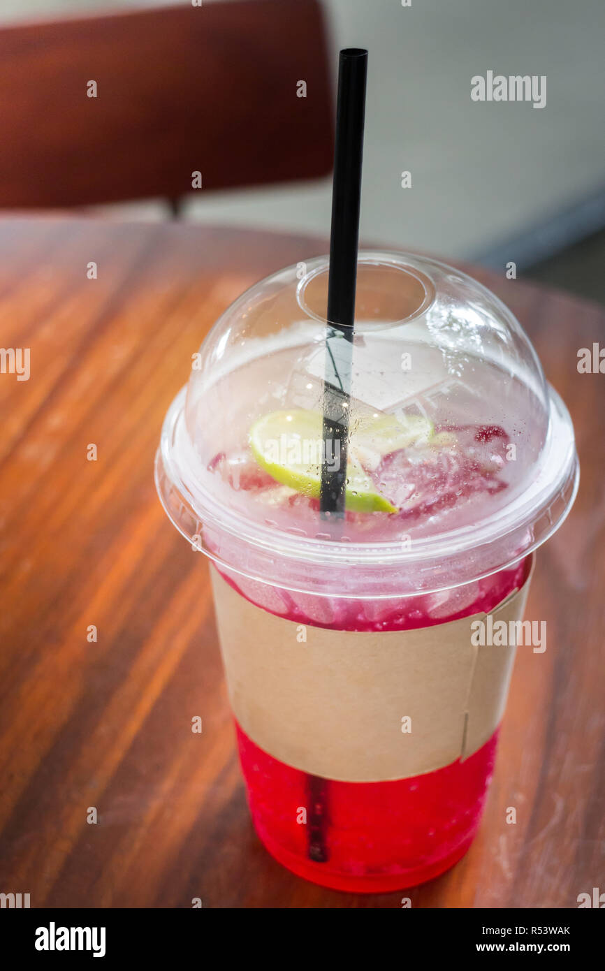 Cold Red Drink With Lime Slice Stock Photo - Alamy