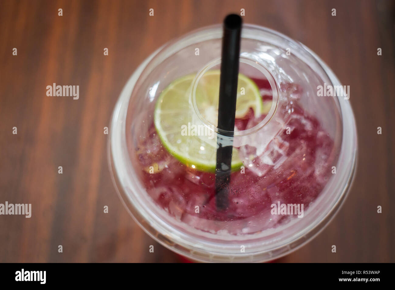 Cold Red Drink With Lime Slice Stock Photo - Alamy