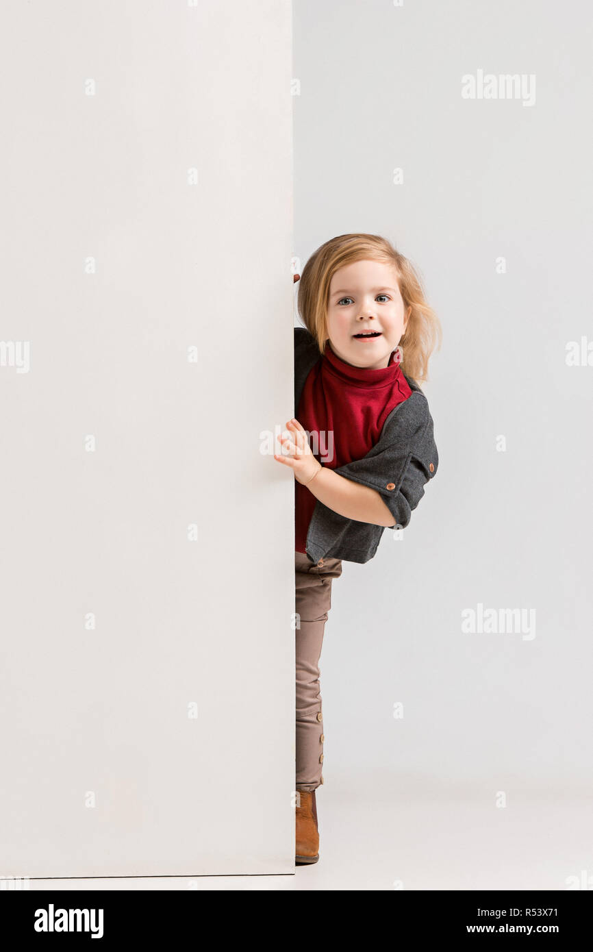 Banner with a surprised child peeking at the edge. portrait of cute ...