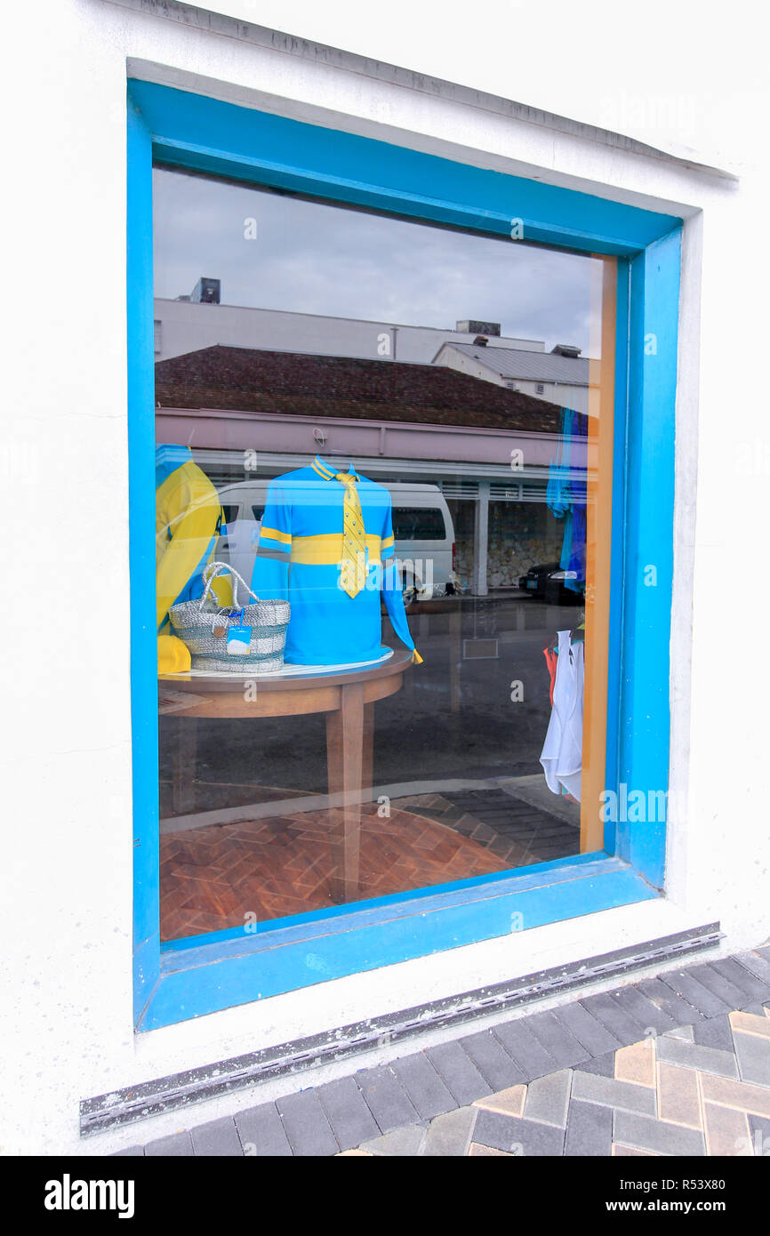 Blue and yellow t-shirts in a blue colored shop window display Stock ...